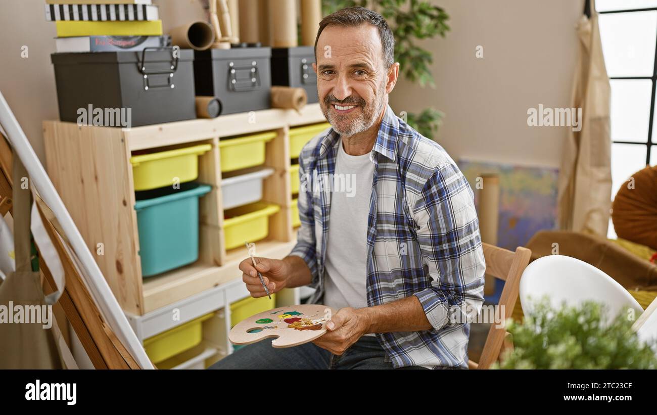 Confident middle-aged man with grey hair, smiling joyfully while ...