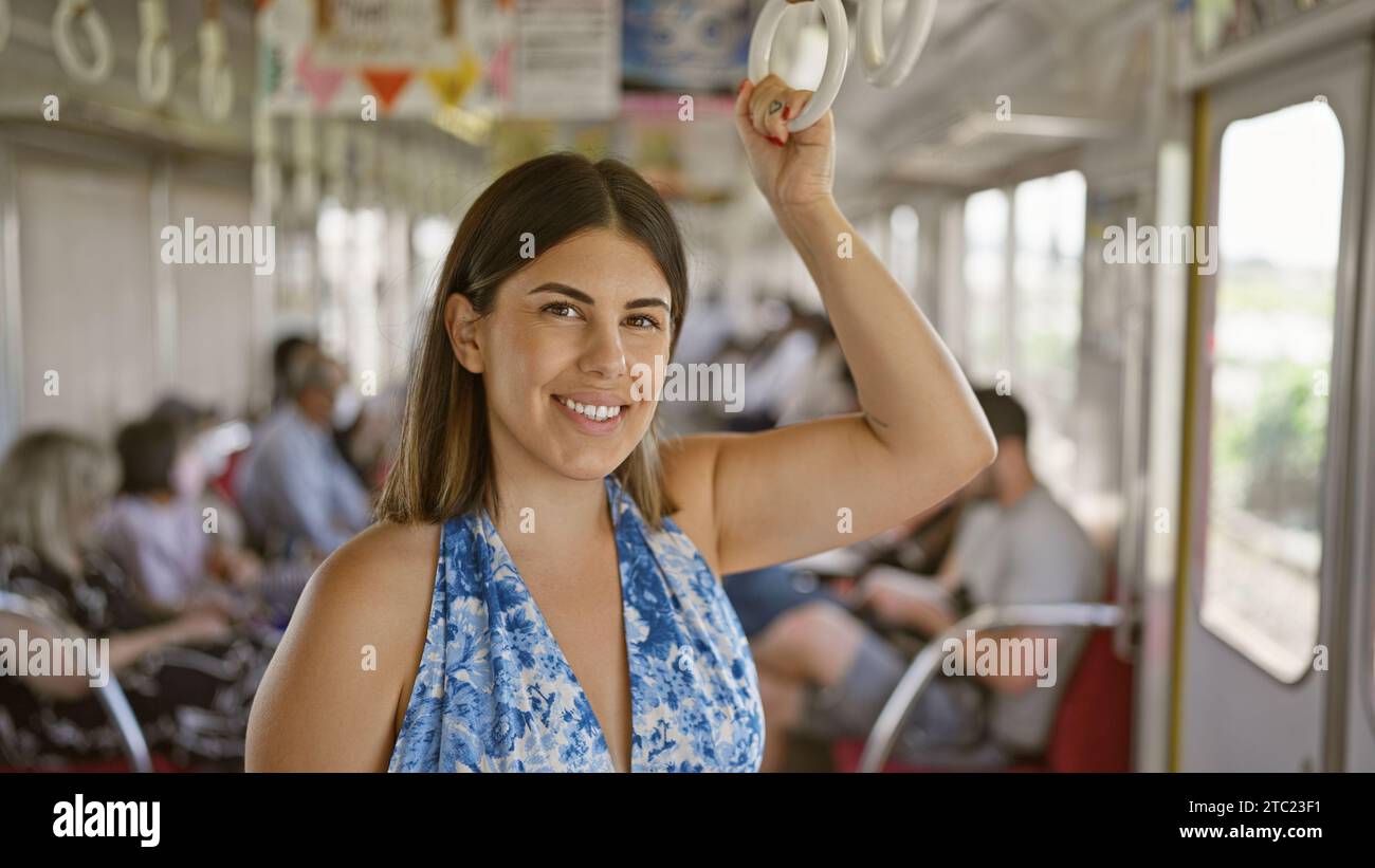 Beautiful hispanic woman standing, smiling at camera inside an empty ...