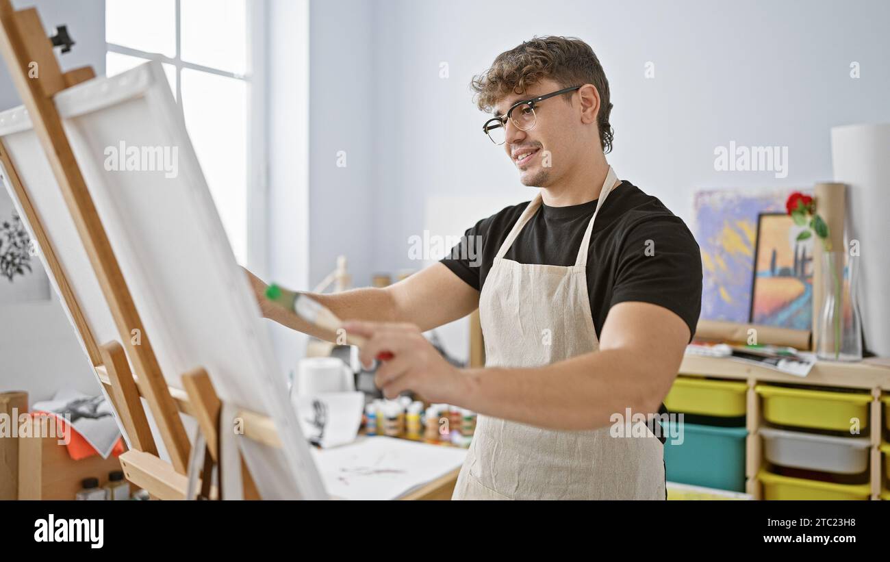 Cheerful young hispanic man, an artist enwrapped in passion ...