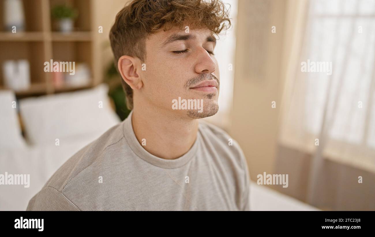 Young handsome hispanic man, deeply concentrating, resting comfortably ...