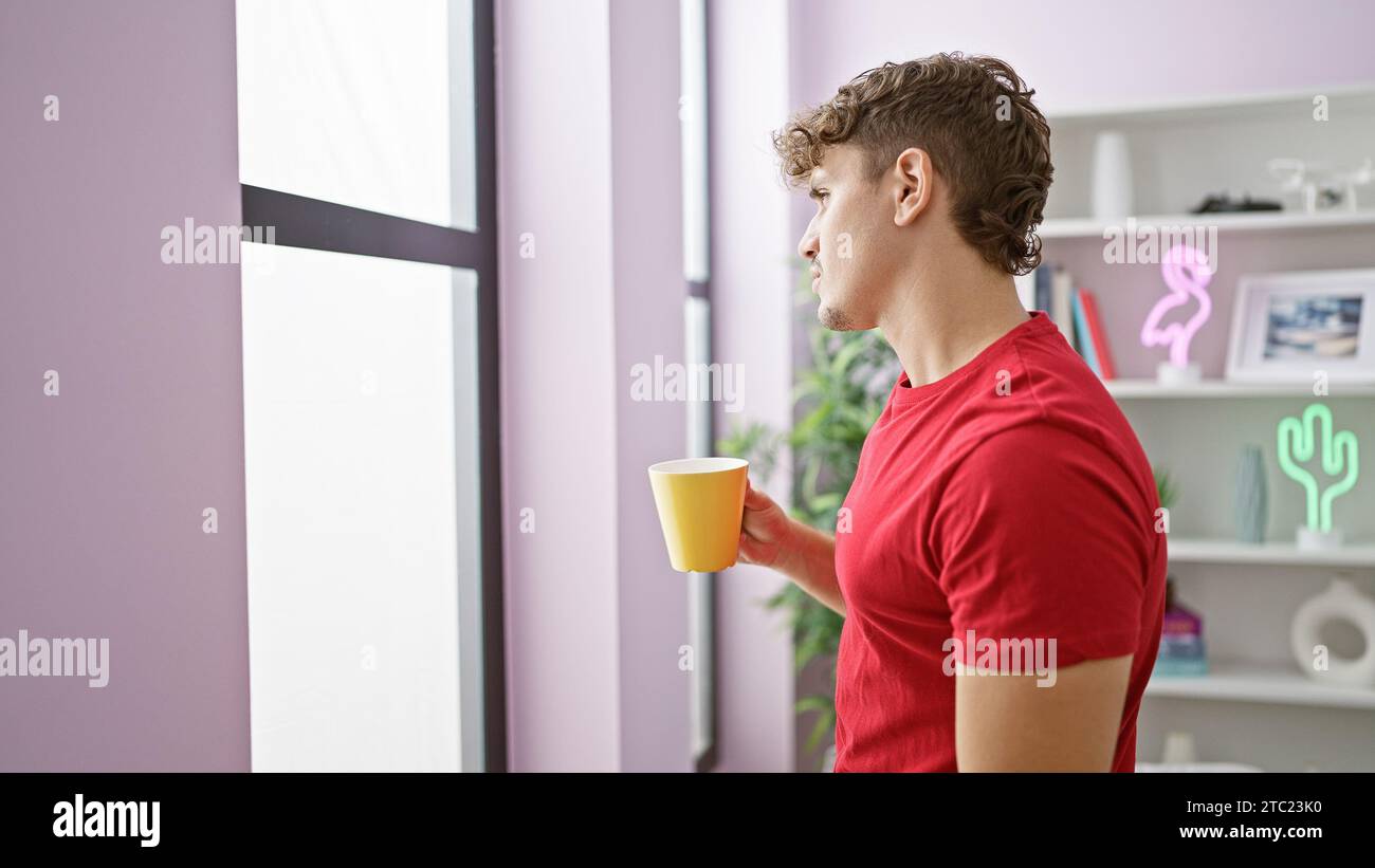 Attractive young hispanic man deeply absorbed in thought, casually ...