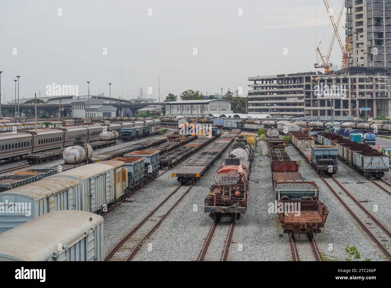 Railway station. Freight old cars and tanks on the railway. Train at ...