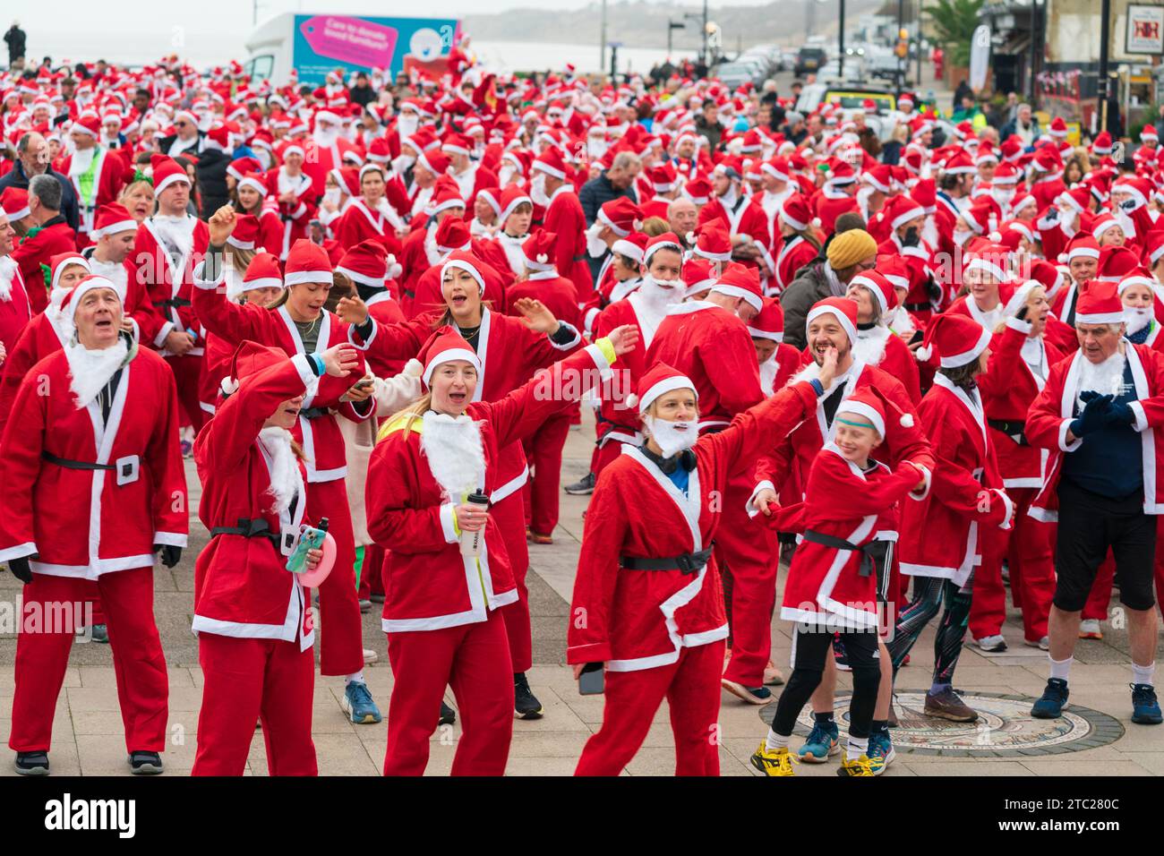 Several hundred people all dressed in red Father Christmas clothing ...