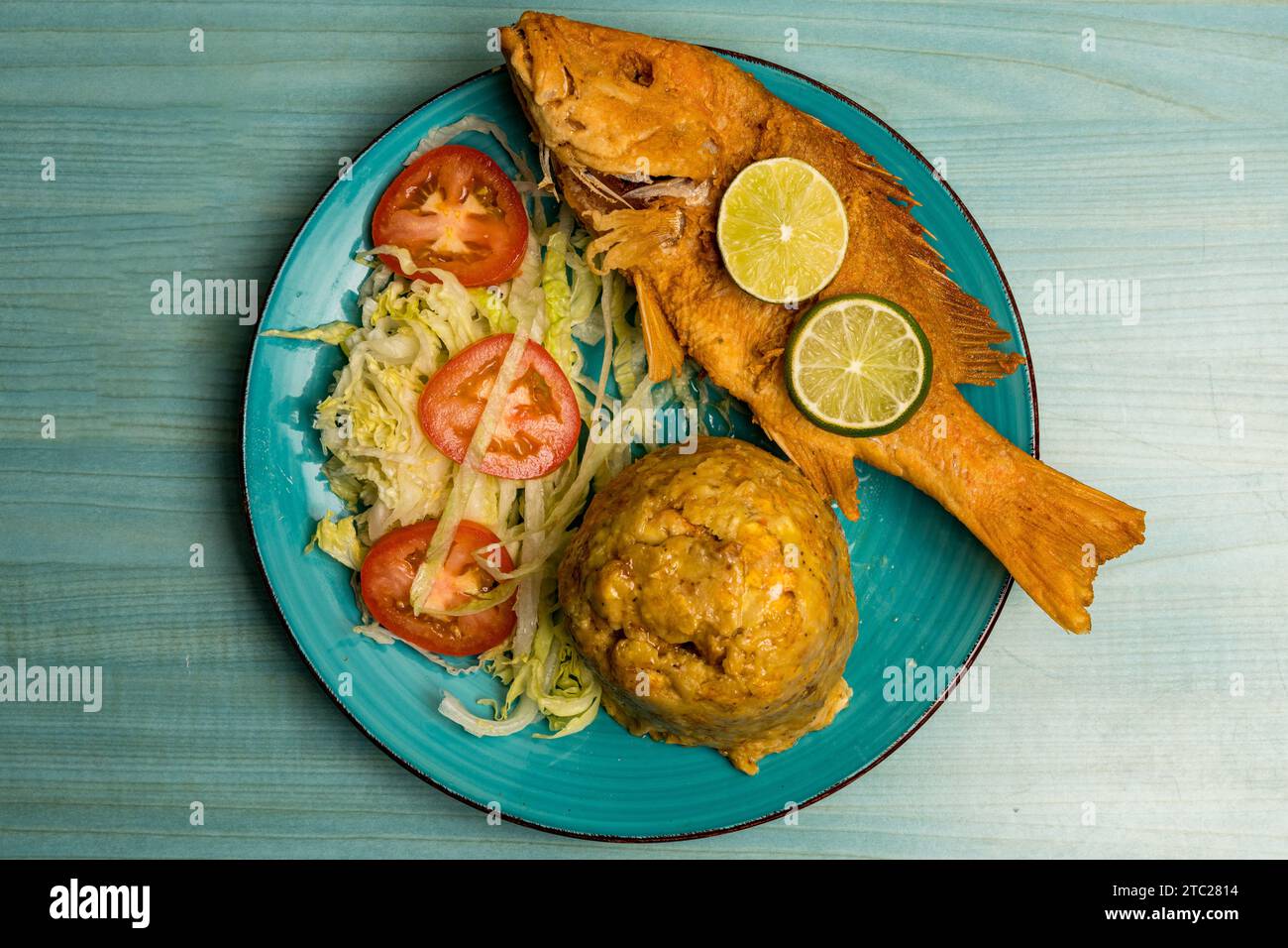 Fried fish with mashed plantains Stock Photo - Alamy