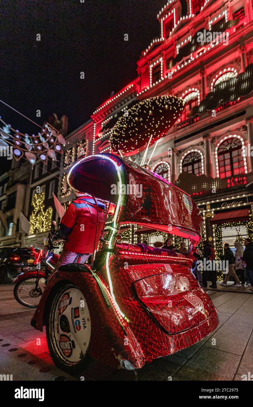 A red London Rickshaw outside the iconic Cartier store in Mayfair ...