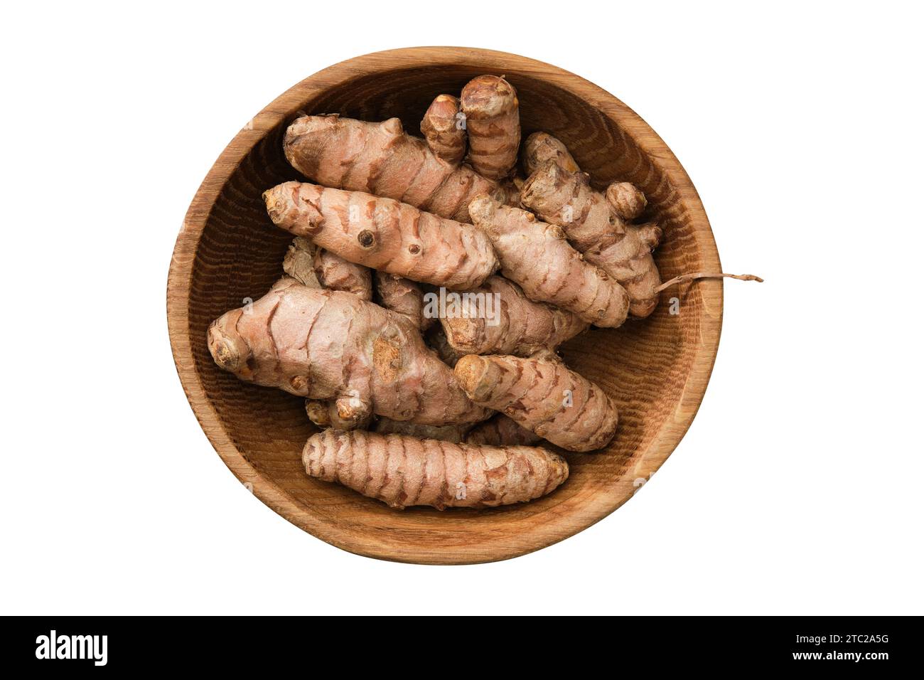 Whole curcuma roots in bowl. Fresh raw turmeric spice, isolated on ...