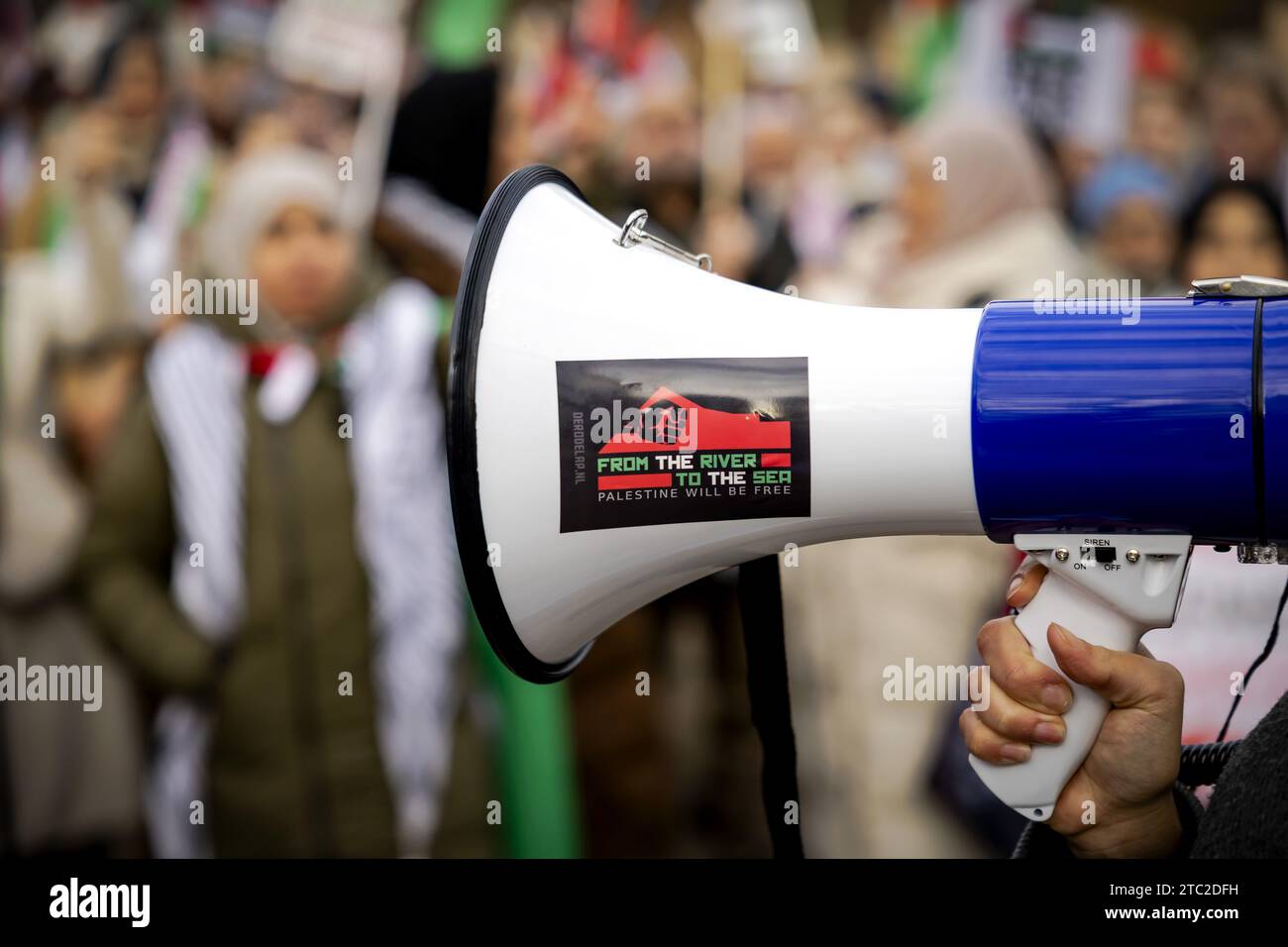 THE HAGUE - A megaphone with a sticker on it that reads “from the river ...