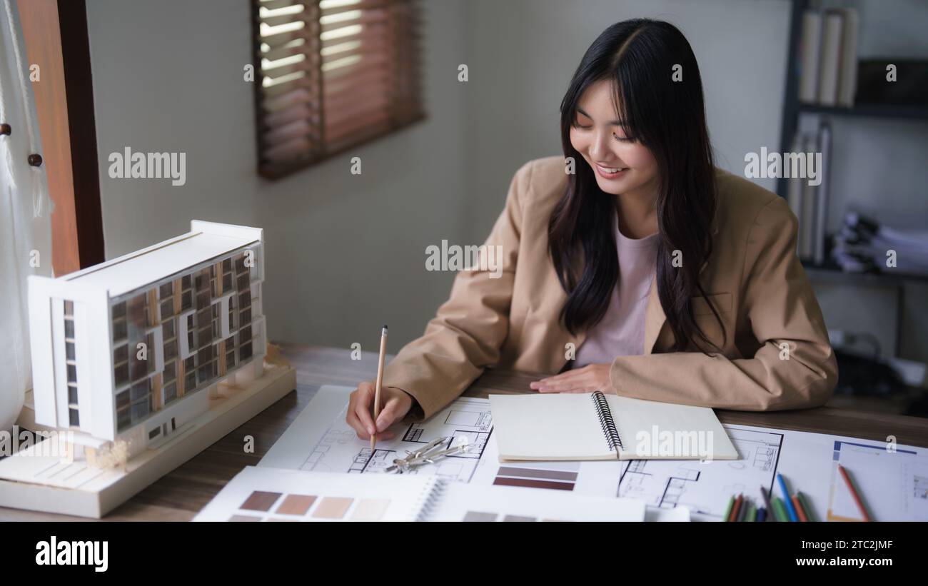 Female architect work to designing architecture interior and drawing ...