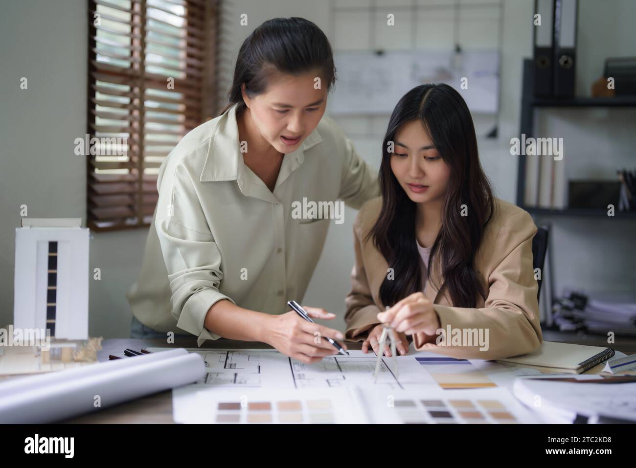 Two female architects discuss interior design building project and use ...