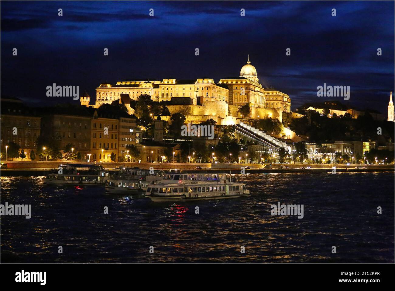 Night view of the enlightened Buda Castle (Budavári Palota) from the Danube River, Budapest ...