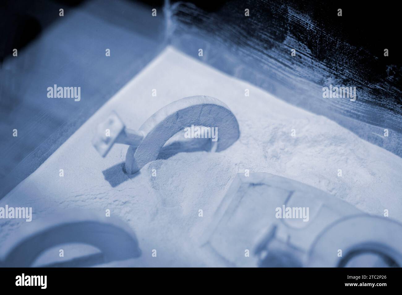 Objects printed on a 3D printer from powdered polyamide lying in white ...