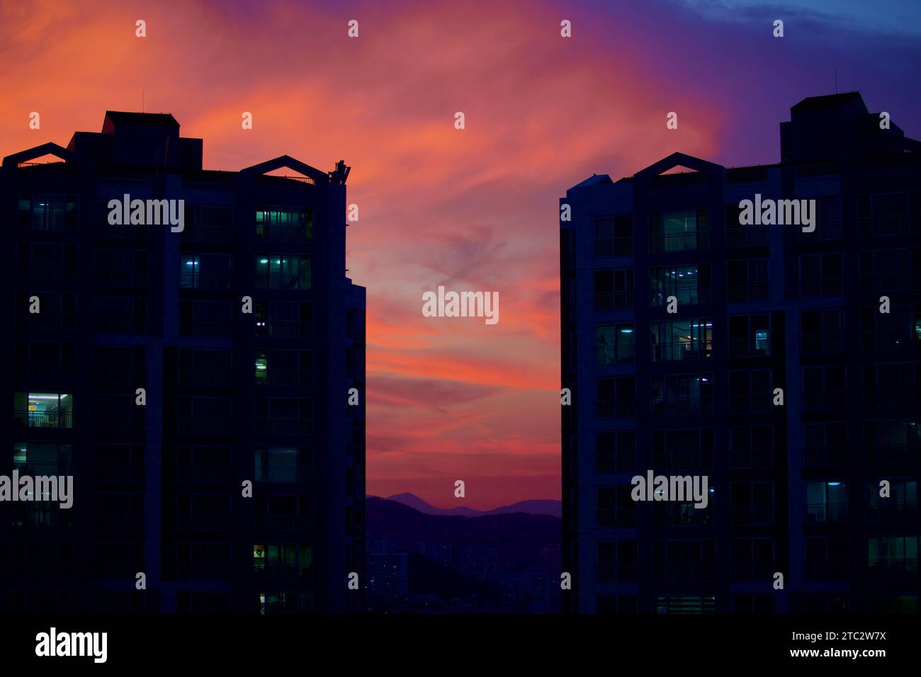 Ulsan's skyline at sunset, with dark apartment silhouettes, vibrant sky ...