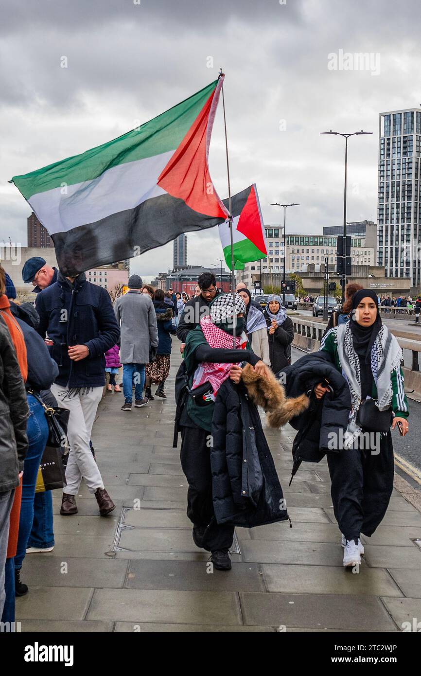 London, UK. 9th Dec, 2023. Protestors walking over Waterloo Bridge come ...