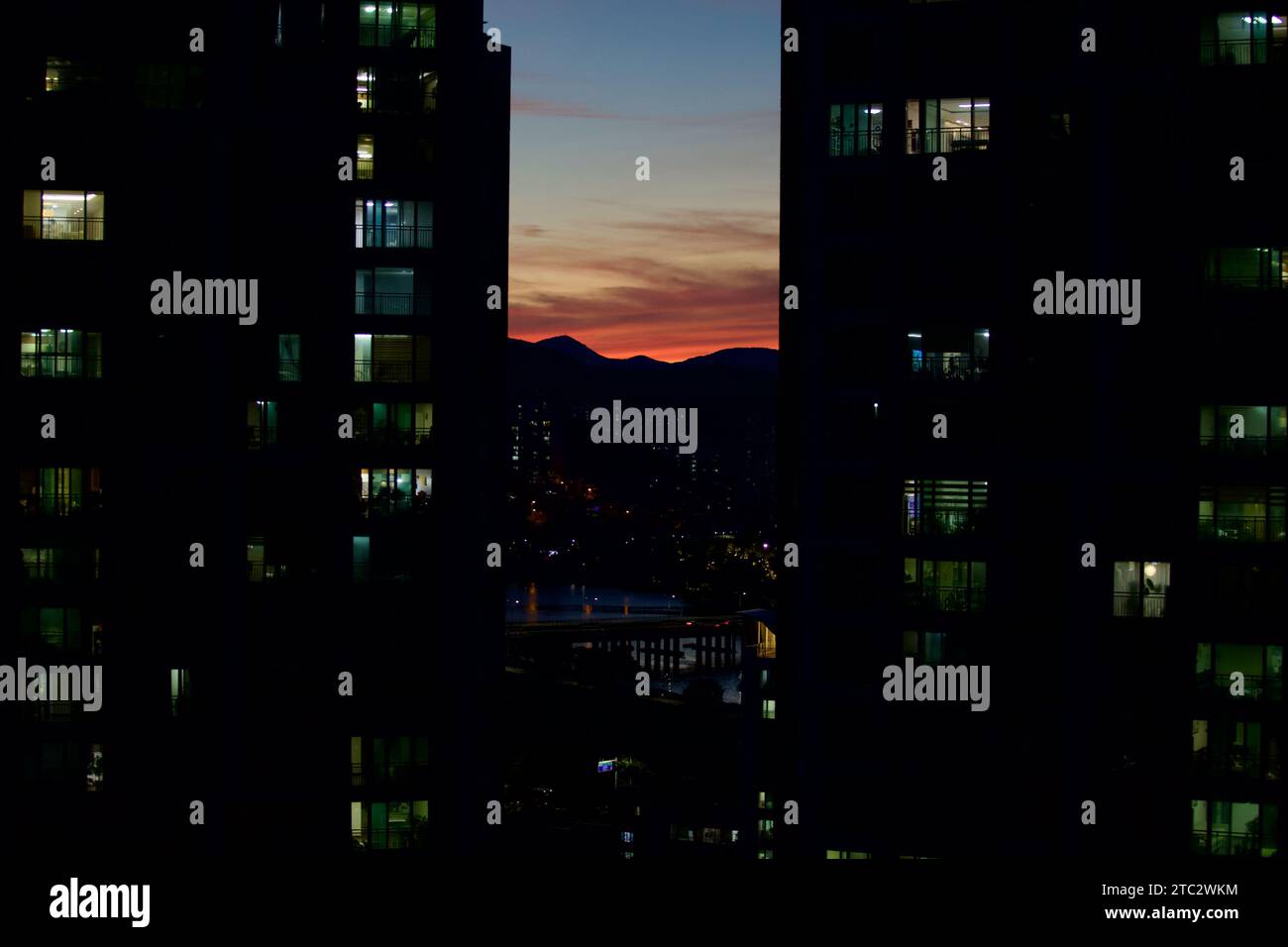 Ulsan's skyline at sunset, with dark apartment silhouettes, vibrant sky ...