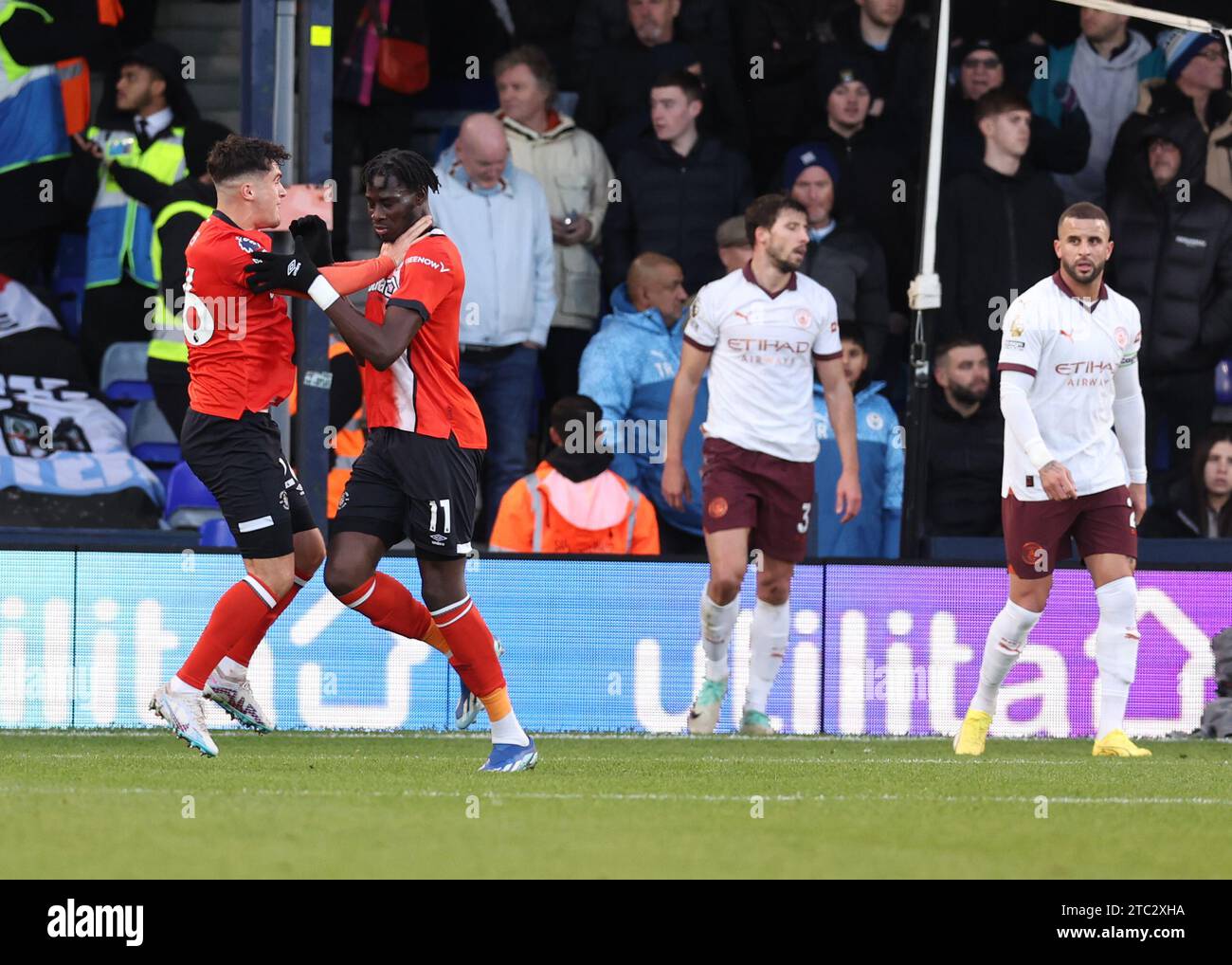 Luton, UK. 10th Dec, 2023. Elijah Adebayo of Luton Town (2l) celebrates ...