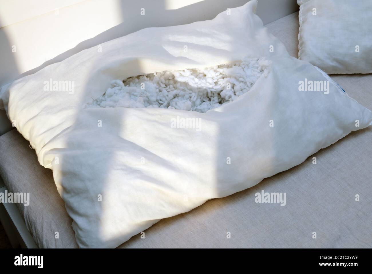 Torn old white pillow on the bed in the bedroom Stock Photo - Alamy