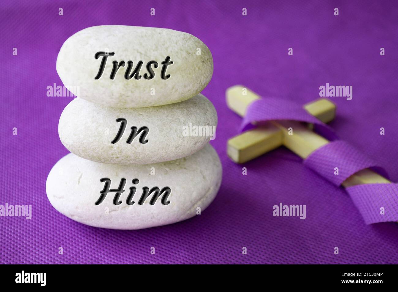 Trust in Him text on stones with Christian cross background. Prayer and ...