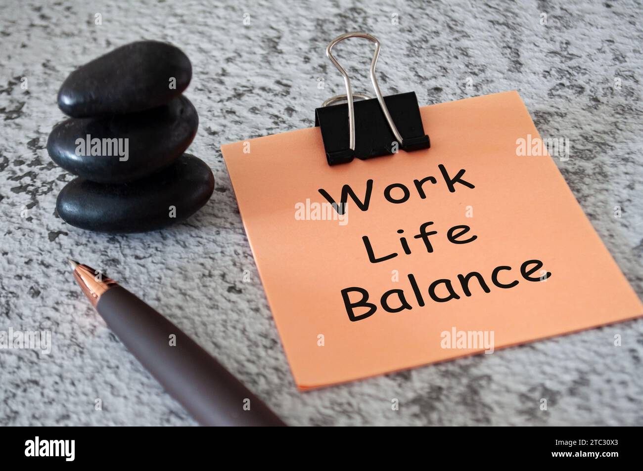 Work life balance text on sticky notes with pen and stack of zen stones ...