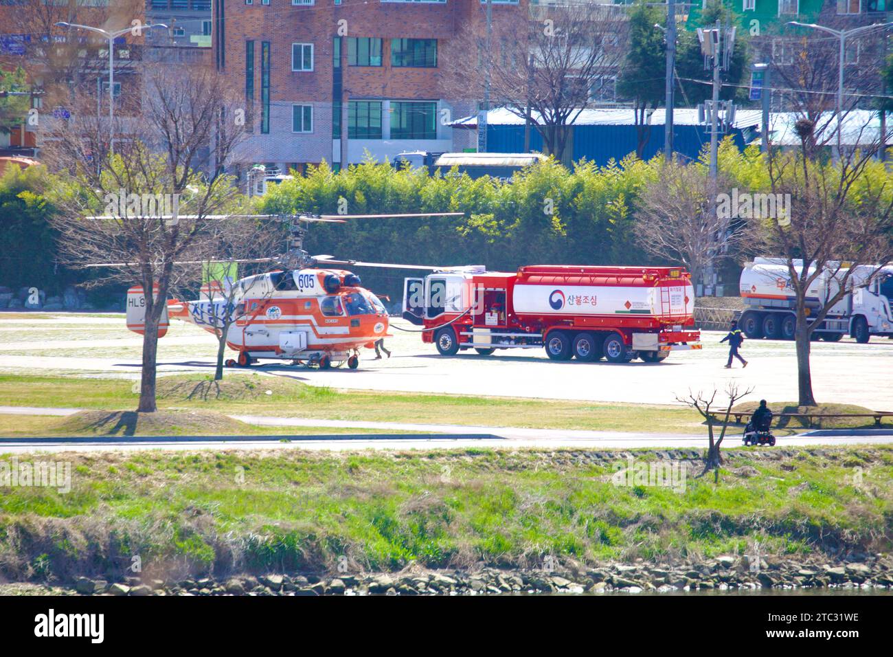 A Korean firefighting helicopter is captured mid-refueling at Taehwa ...