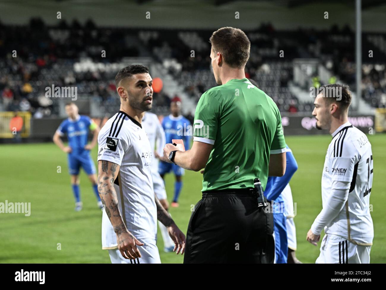 Eupen, Belgium. 10th Dec, 2023. Eupen's Victor Palsson and referee ...