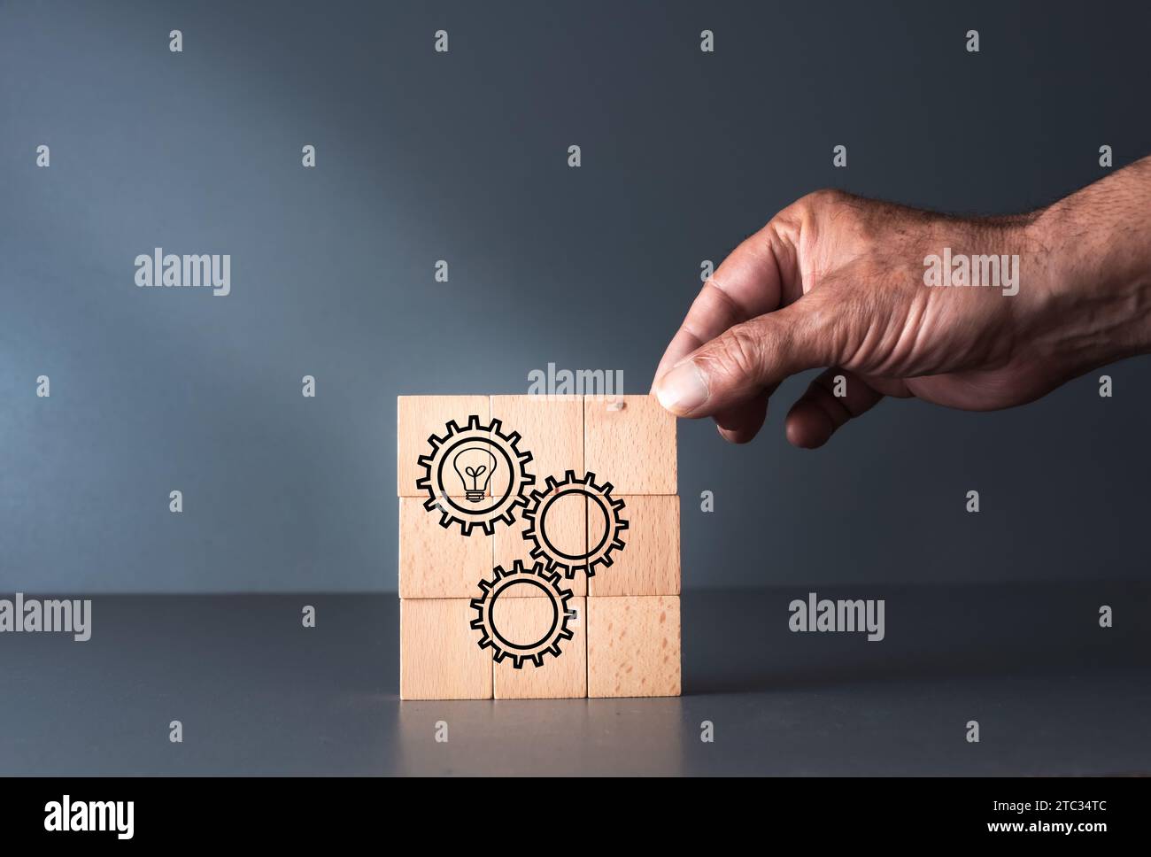 hand posing wooden blocks with cog wheels ,concept of Automation for ...