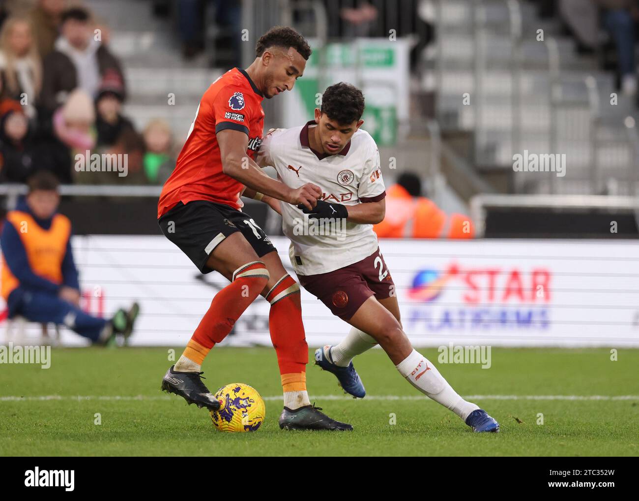 Luton, UK. 10th Dec, 2023. Jacob Brown of Luton Town tussles with ...