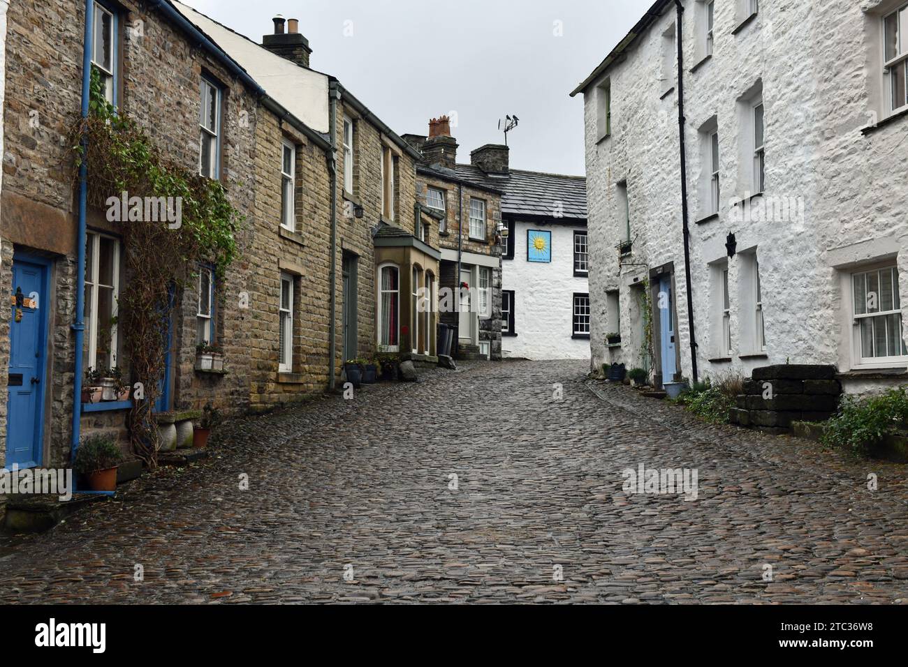 The cobbled main street through Dent village in Dentdale - in the ...