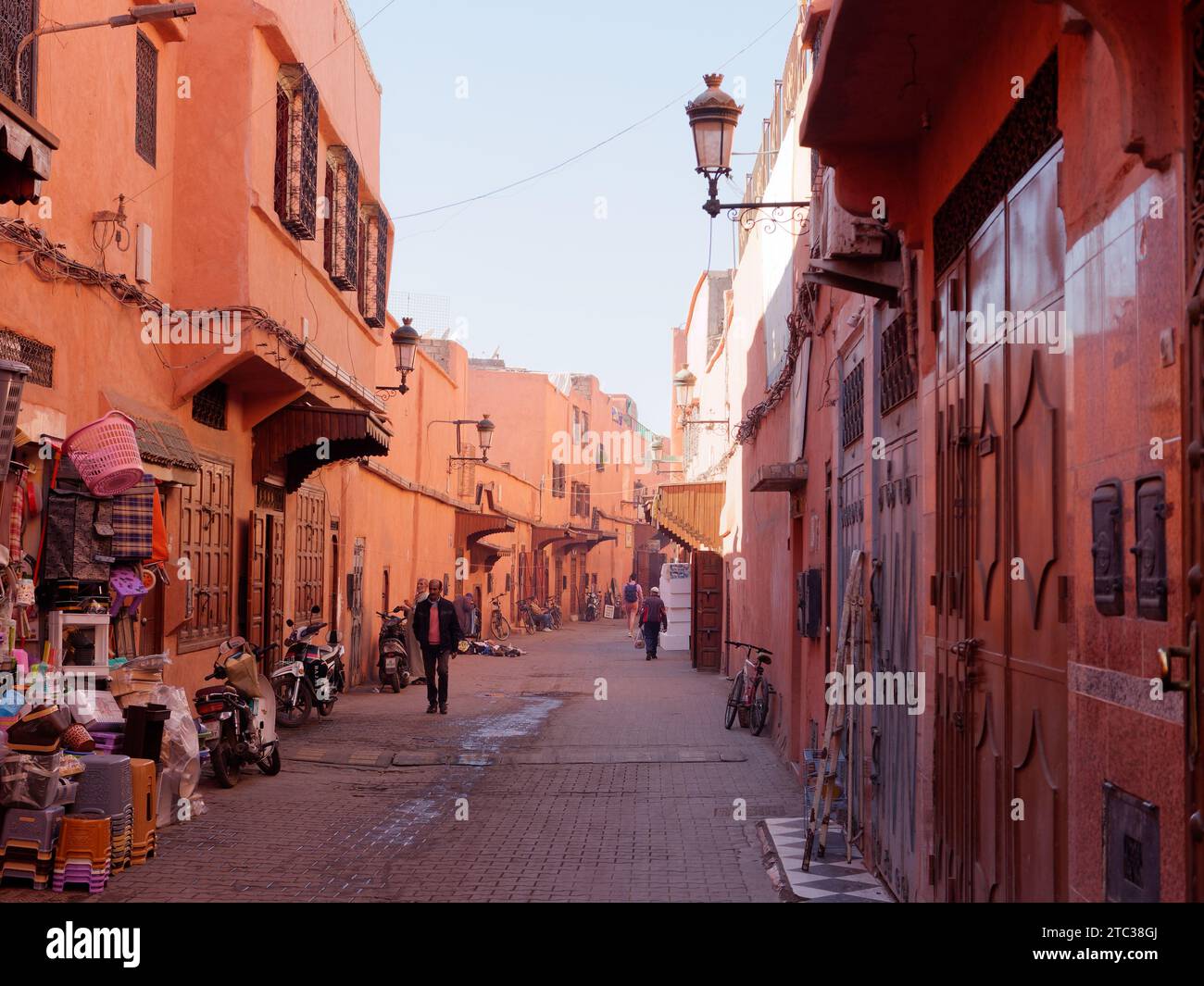 Street vendors and red clay buildings in the Medina in Marrakesh aka ...