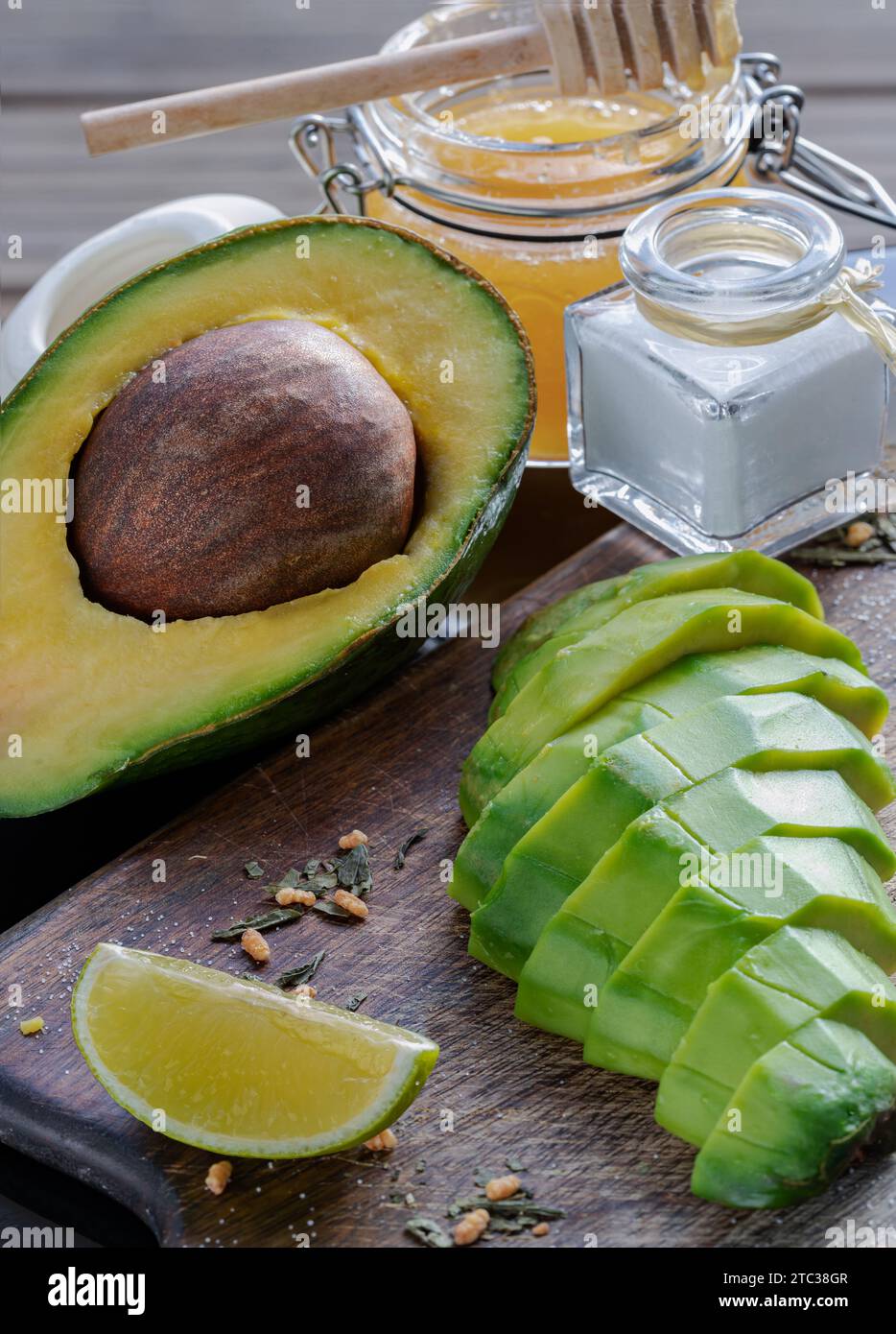 Fresh organic sliced avocado and Sliced avocado halves with lime slice ...