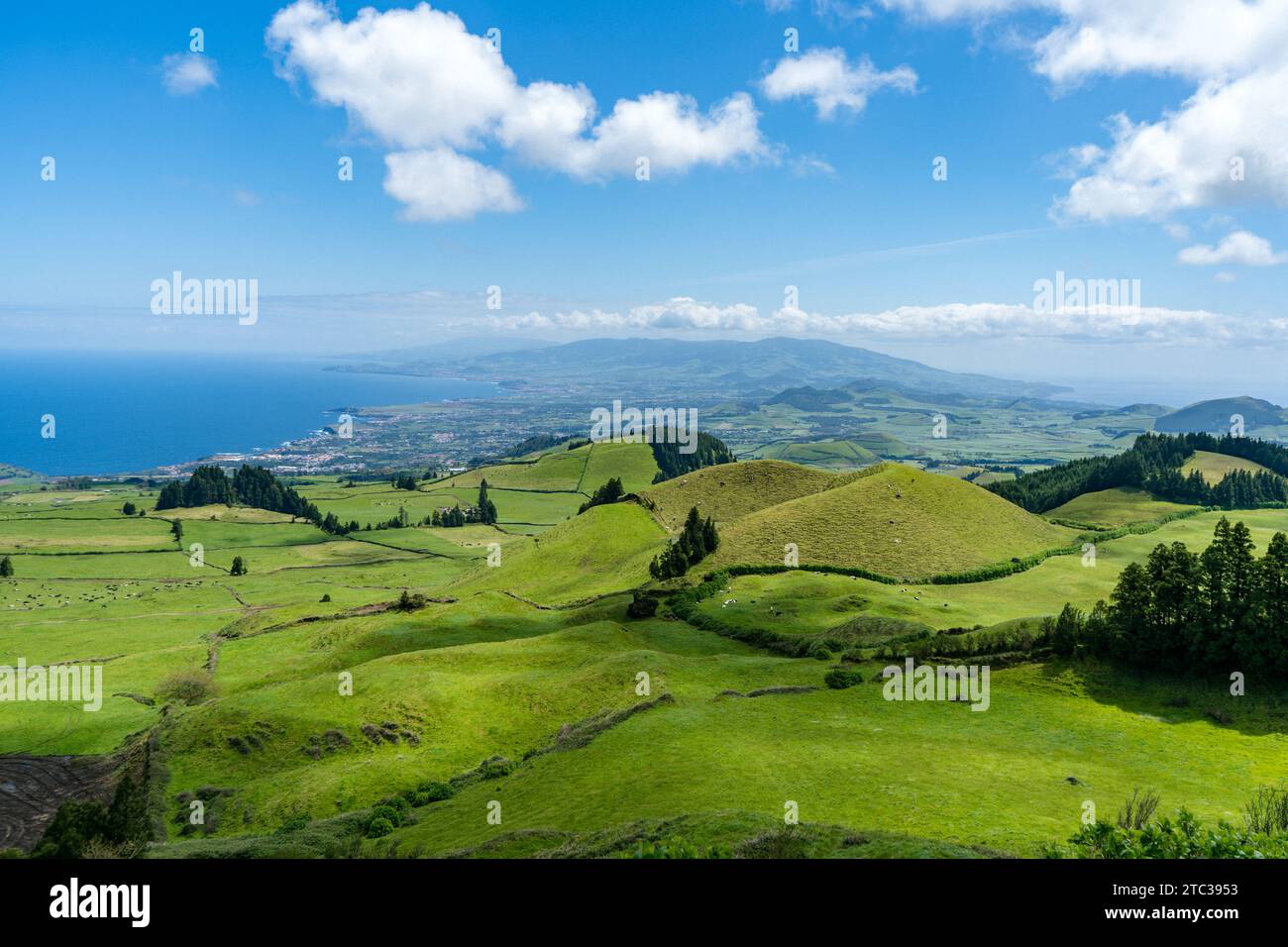 Azores landscape: expansive green fields leading to small mountains ...