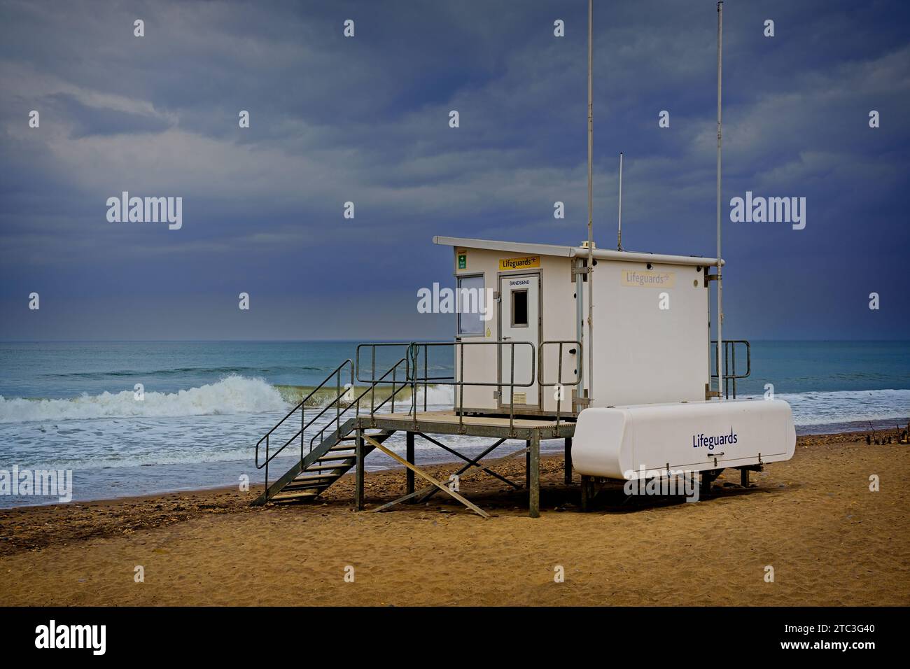 A gloomy, dramatic scene depicts a white lifeguard station amidst an ...