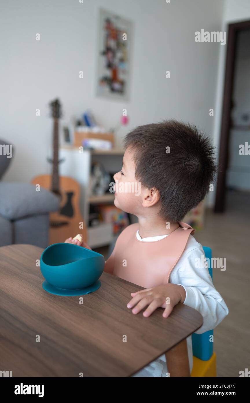 Witness the adorable scene of a baby boy, dressed in pajamas ...