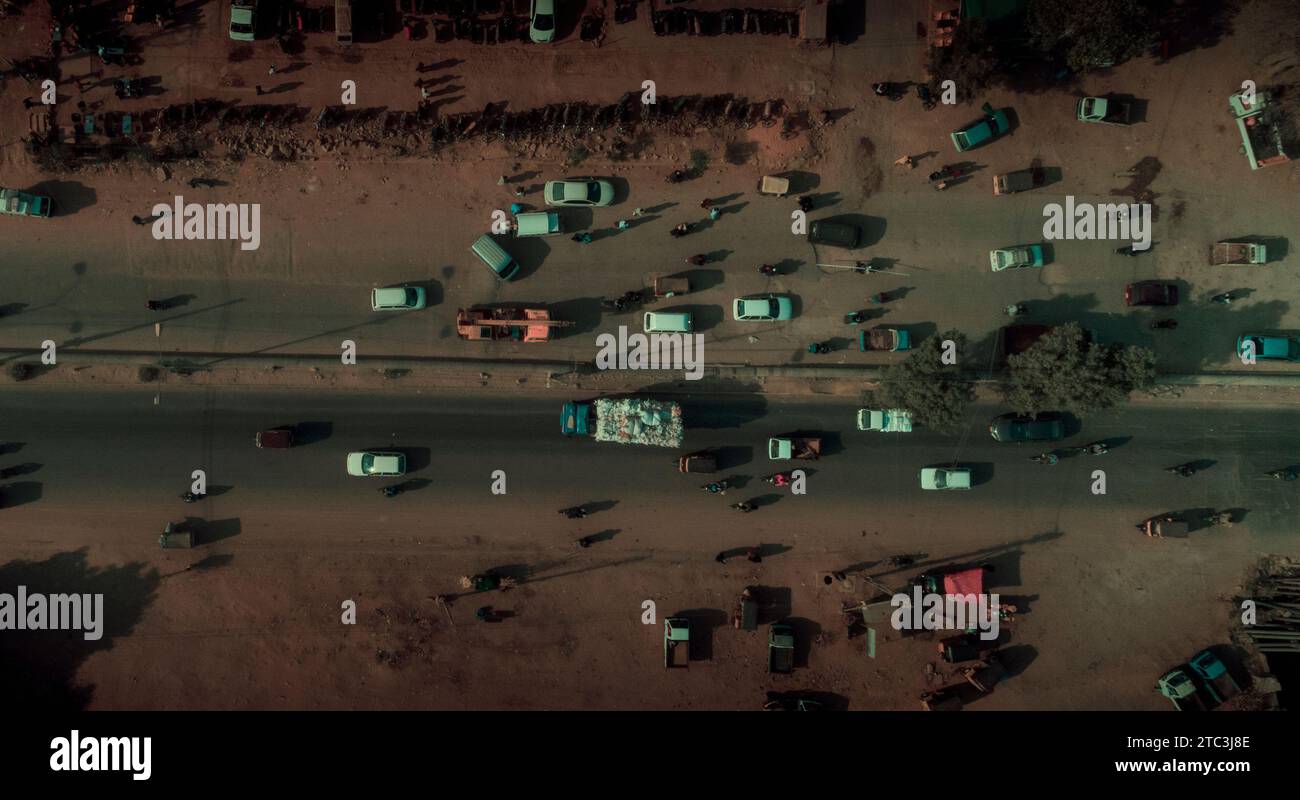 Aerial view of a street lined with parked vehicles of various types and ...