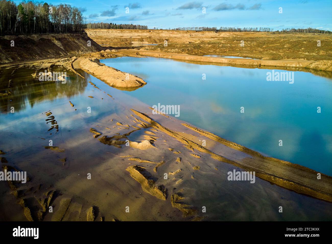 Aerial view of the territory of a large sand quarry with a pond ...