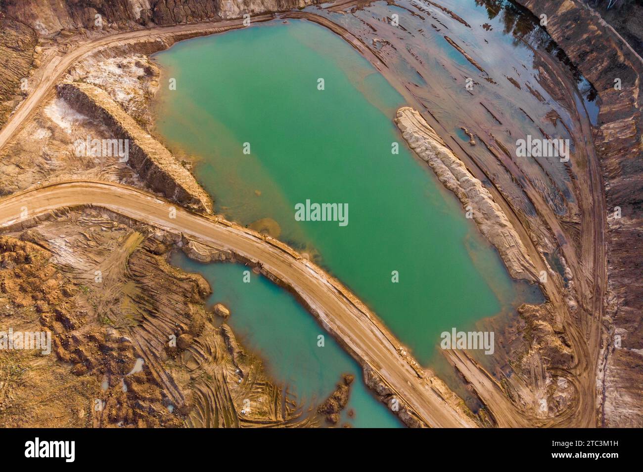 Aerial view of the territory of a large sand quarry with a pond ...