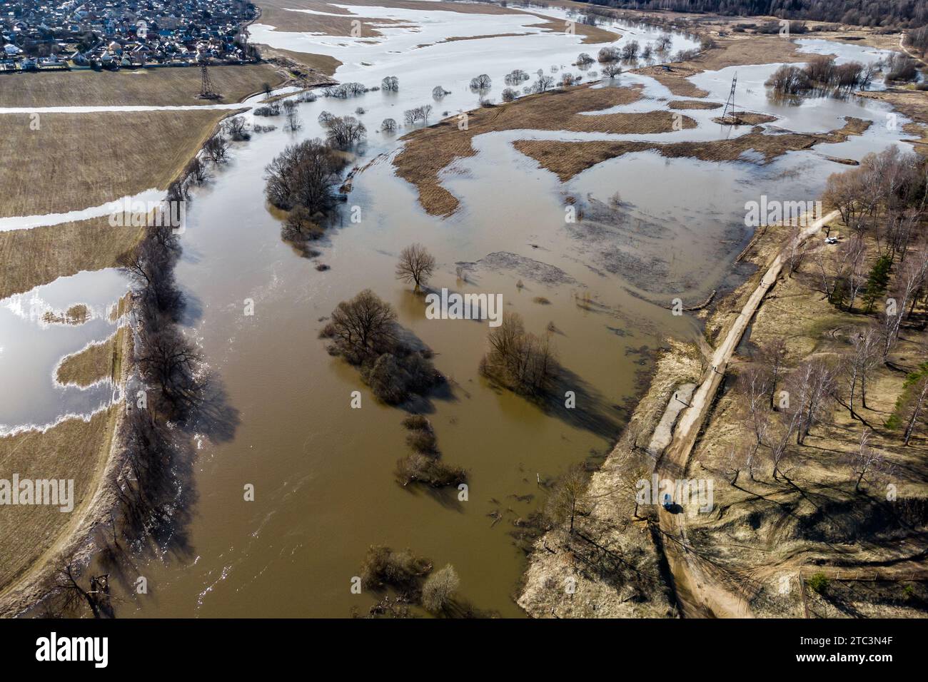 Aerial view of an overflowing river and flooded fields during spring ...
