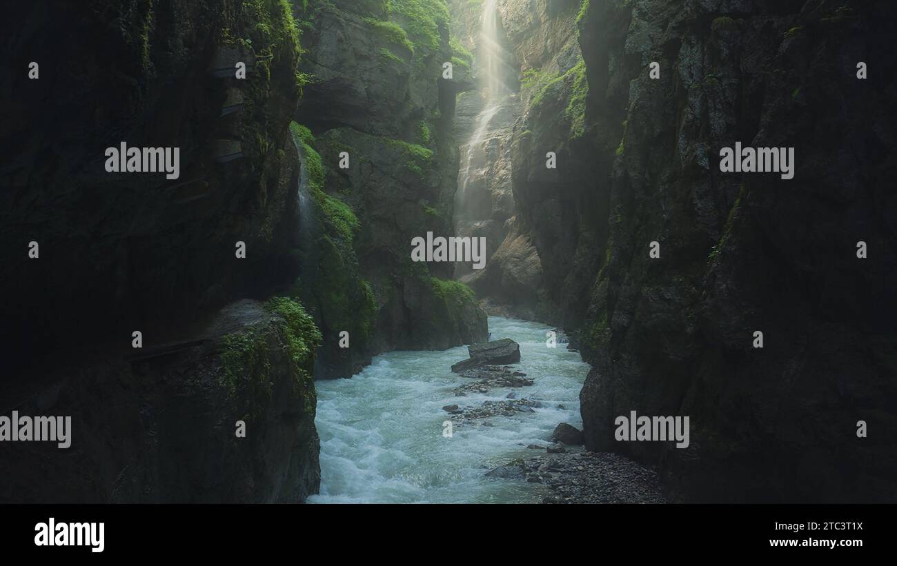 A flowing river winds its way through a picturesque mountain canyon ...