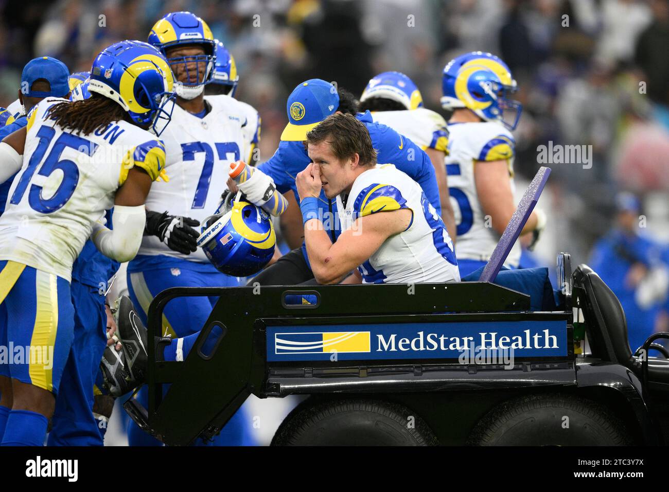 Injured Los Angeles Rams tight end Hunter Long sits on a cart as Rams ...