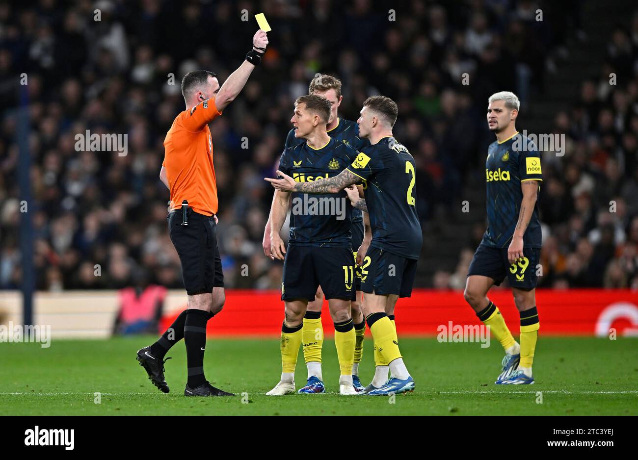 London, UK. 10th Dec, 2023. Chris Kavanagh (Referee) shows the yellow ...