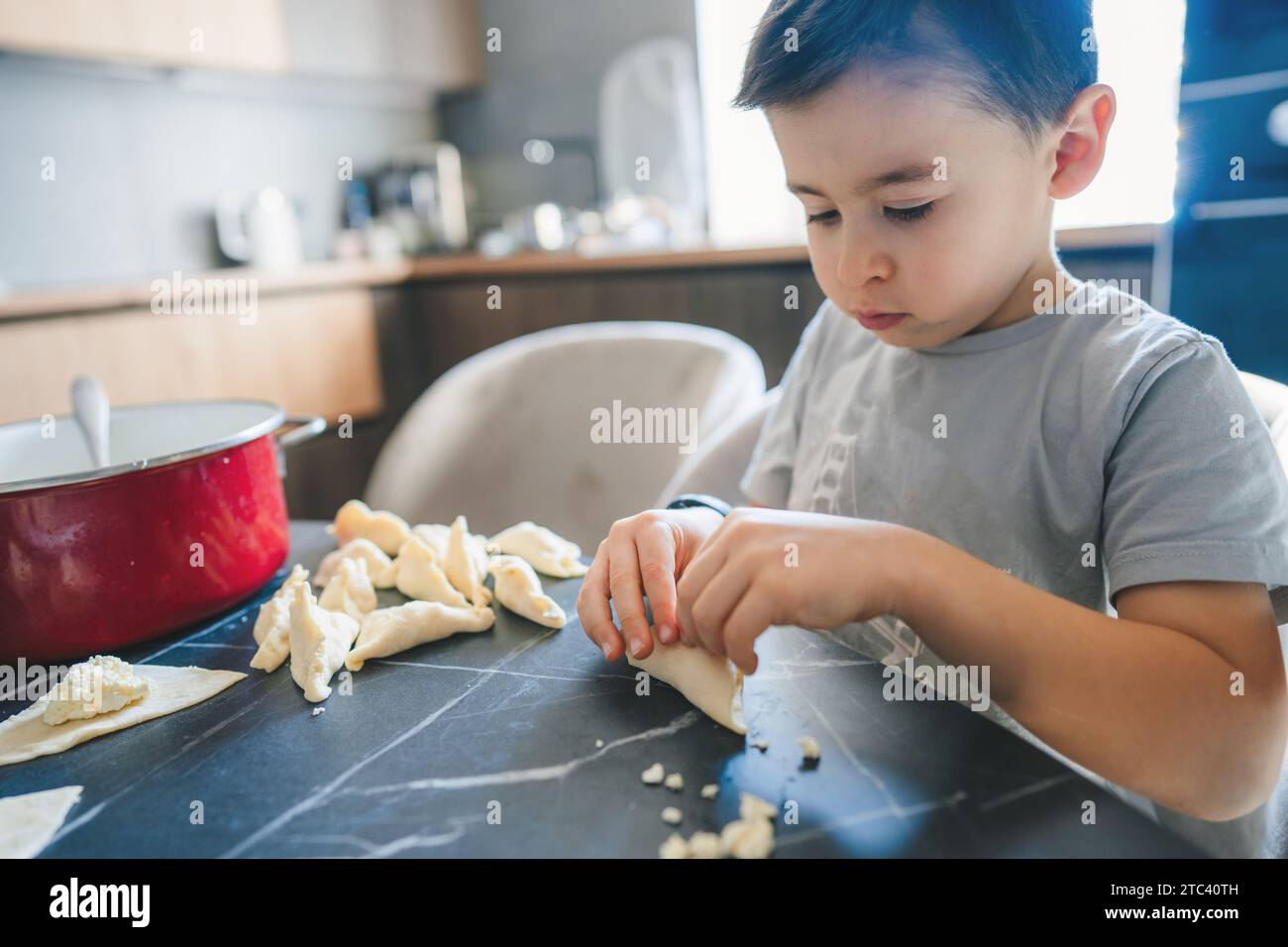 Cute little boy sculpting dumplings for dinner. Child helping in the ...