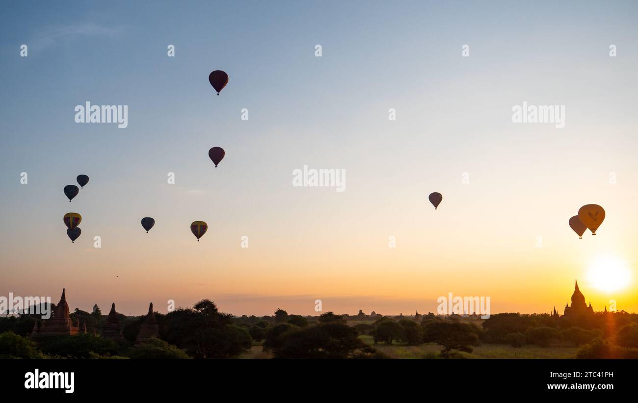 Aerial view of a picturesque landscape featuring many colorful hot air ...