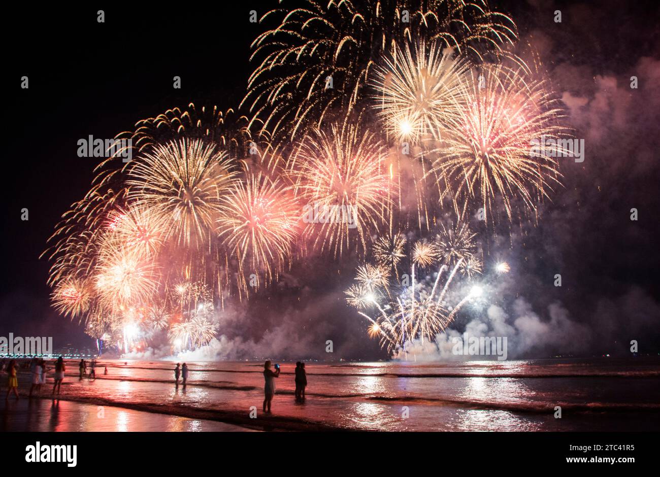 New Year on the beach. Celebrating with exploding colorful fireworks ...