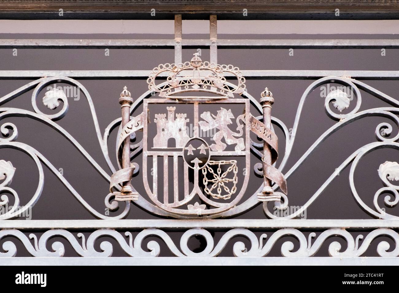 Shield of the kingdom of Spain, on a metal fence, with the motto Plus ...