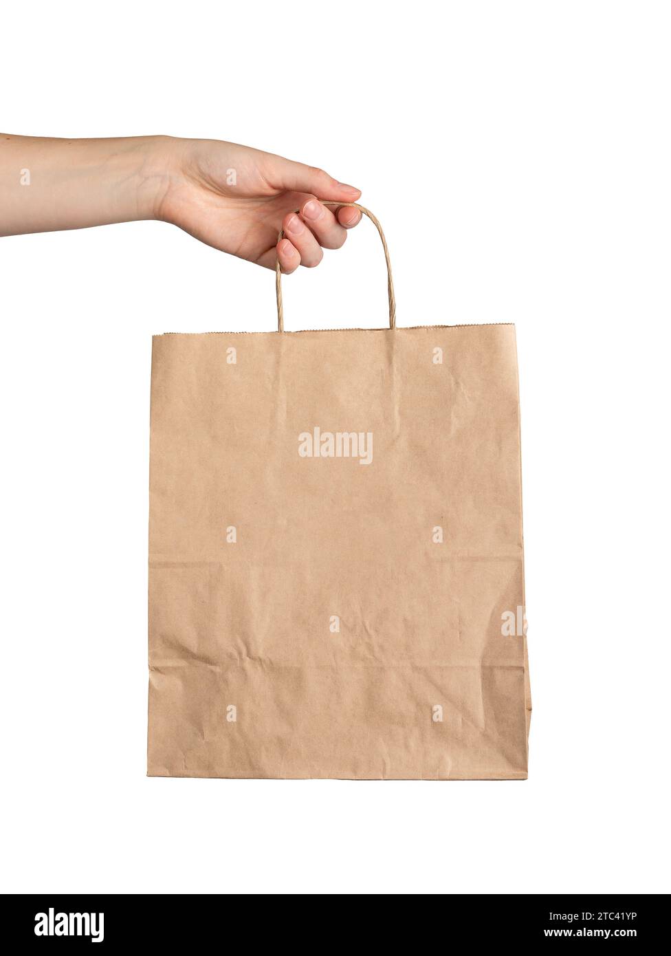 Hand holding paper bag, kraft brown packet mockup isolated on white ...