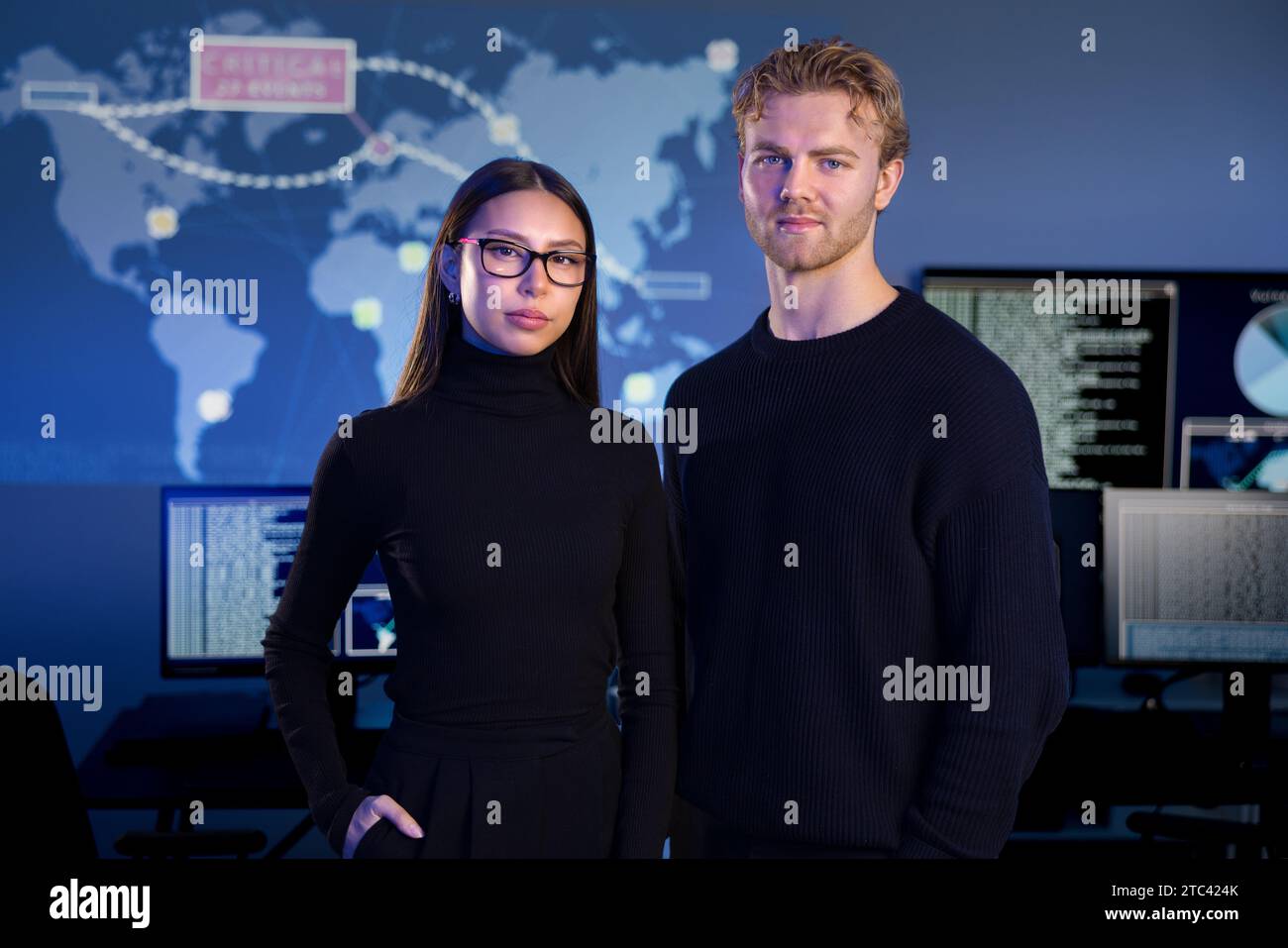 Professional and confident cyber security team in front of dark ...