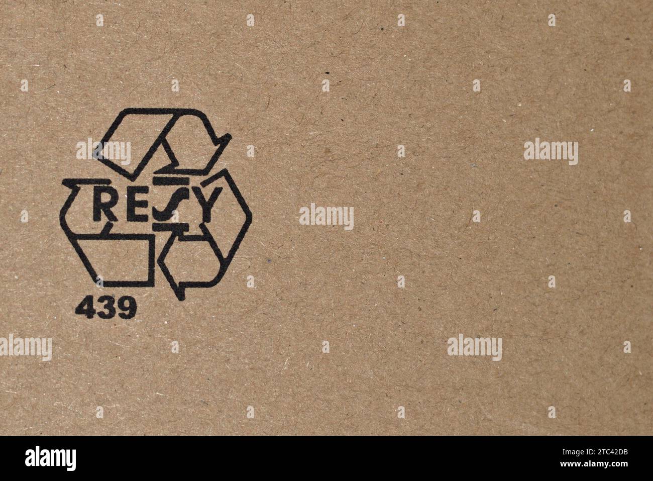 Recycling symbol on the cardboard box. Negative copy space for ...