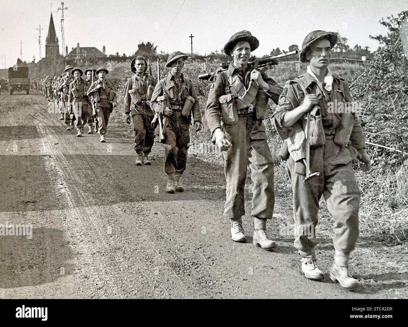 NORMANDY LANDINGS British soldiers advancing thruga French village in ...