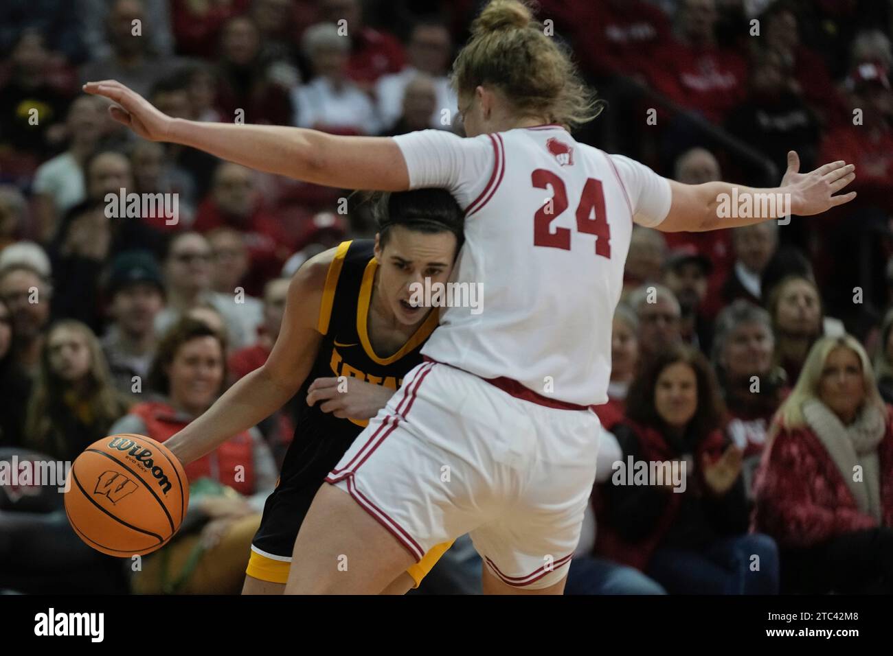 Iowa's Caitlin Clark tries to get around Wisconsin's Natalie Leuzinger ...