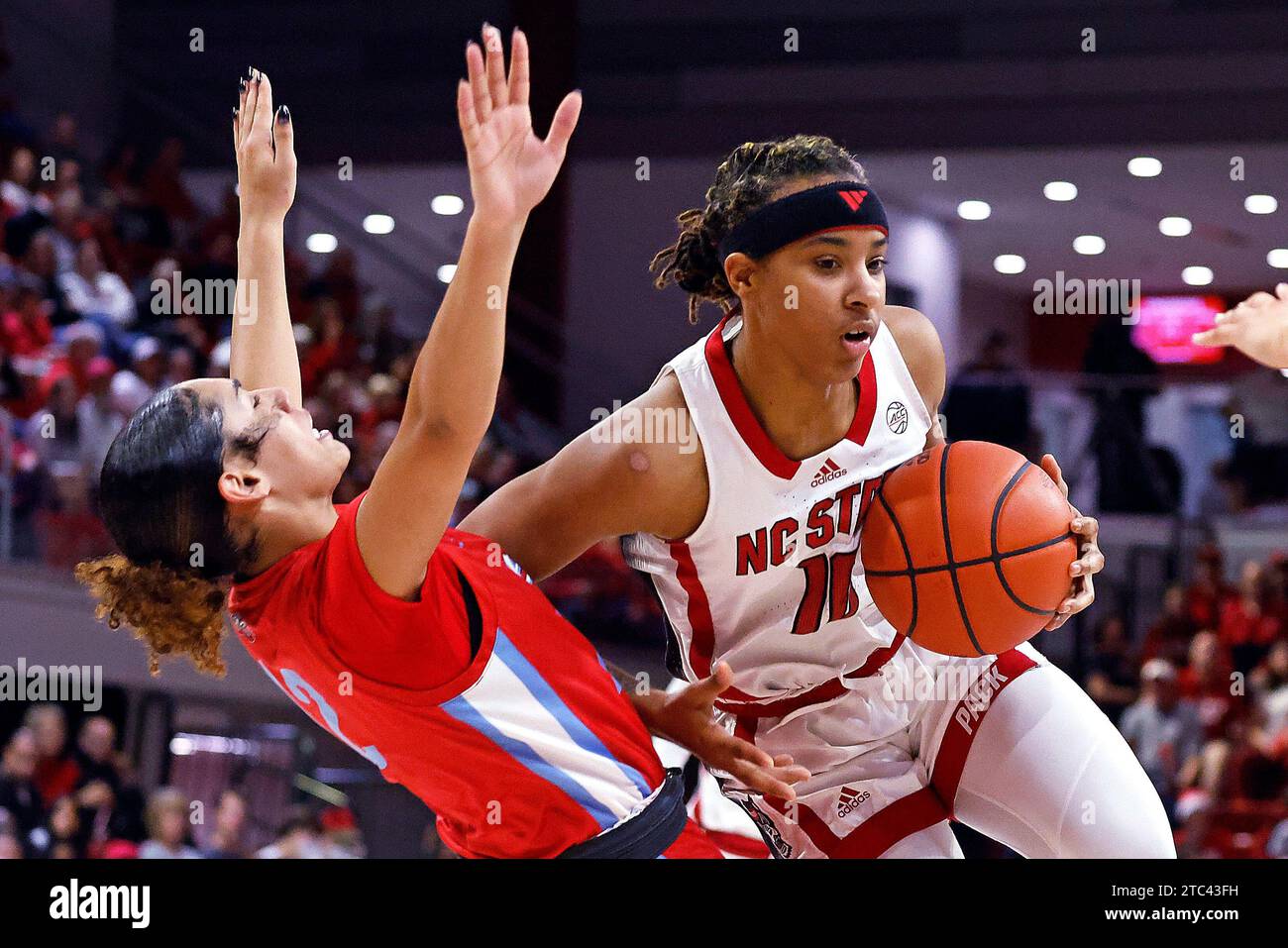 North Carolina State's Aziaha James (10) charges into Liberty's Asia ...
