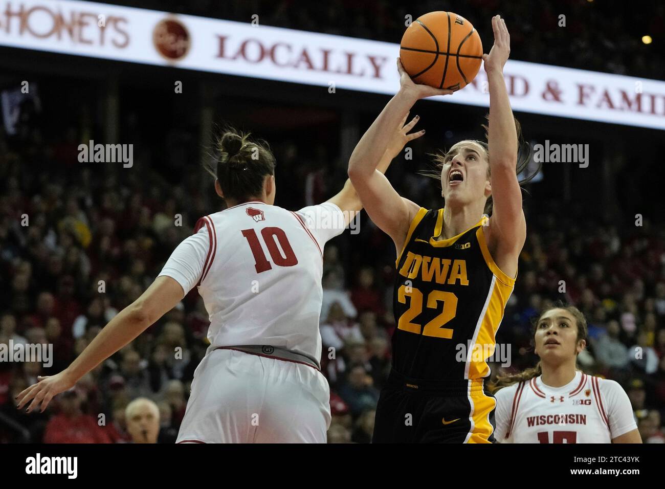 Iowa's Caitlin Clark shoots past Wisconsin's Halle Douglass during the ...